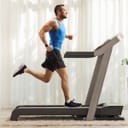 treadmill (【Noun】an exercise machine with a moving surface that you ...