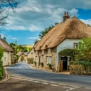 thatched (【Adjective】(of a building or roof) covered with straw ...