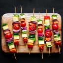 skewer (【Noun】a long piece of wood or metal used for holding pieces of ...