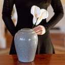 urn (【Noun】a tall, rounded container, especially one used for storing ...