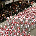 parade (【Noun】a large number of people or vehicles moving together ...