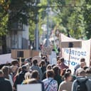 march (【Verb】to walk along public roads as part of a group as a way of ...