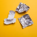 wrapper (【Noun】a piece of paper, plastic, etc., that covers something ...